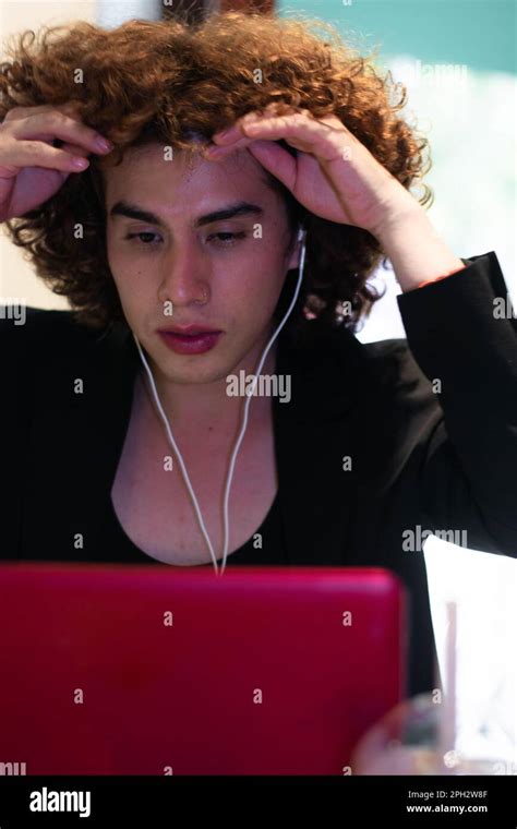 A Non Binary Person Shows An Upset Expression In Front Of A Laptop