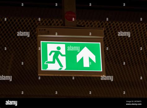 Symbolic Image Escape Route Green Illuminated Sign With Direction Arrow For Emergency Exit