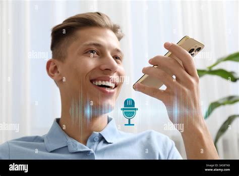 Young Man Recording Voice Message Via Smartphone At Home Illustration Of Microphone And Sound