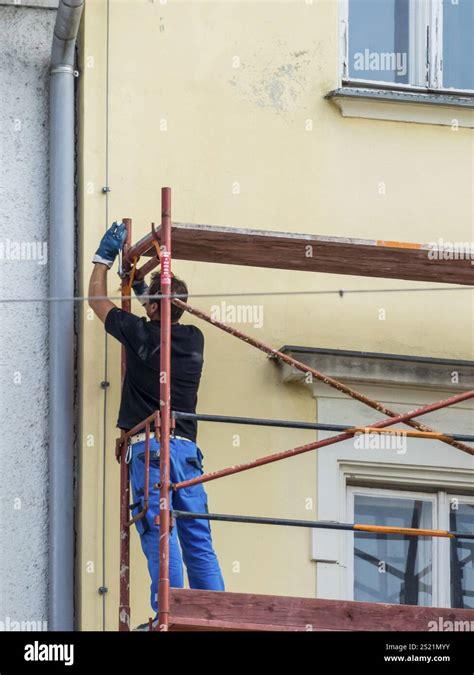 Construction Worker Erecting Scaffolding On A Building Site Austria Stock Photo Alamy