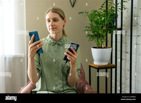Woman Transfer Data From Old To New Phone With Cable Connection Stock Photo Alamy