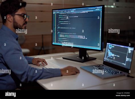 Software Developer Programmer Working Late On Computer In Dark Office