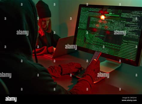 Anonymous People Using Computer And Programming To Break Code Cyber