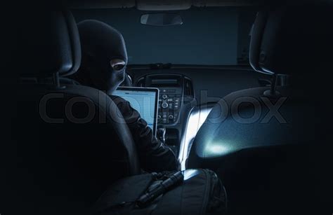 Hacking Car System Car Hacker In Black Mask Hacking Vehicle Systems From Inside The Car Using