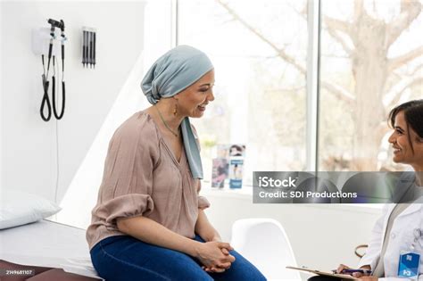 Mid Adult Female Cancer Patient Smiles While Meeting With Her