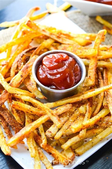 French Fries With Ketchup And Mustard On A White Plate Next To Dipping