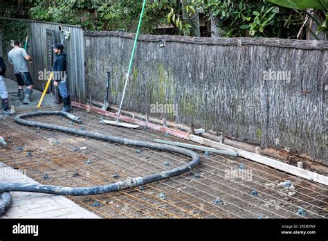 Builders Pour Concrete To Lay New Driveway At The Side Of An Australian Home In Sydney NSW