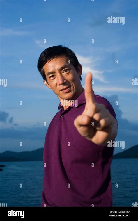 Portrait Of A Mid Adult Man Pointing Forward Stock Photo Alamy