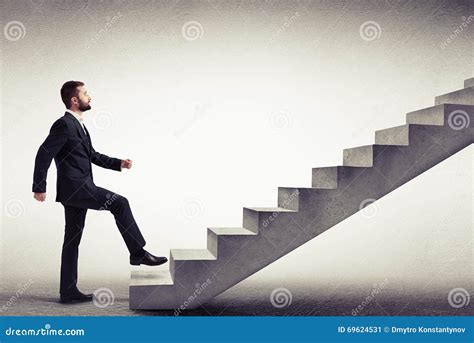Side View Of A Man In A Formal Wear Climbing Concrete Stairs Stock