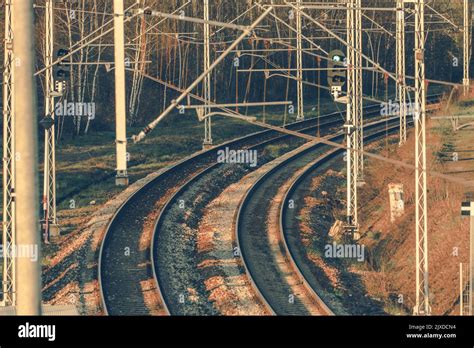 Two Sets Of Parallel Railroad Train Tracks Under Electric Power