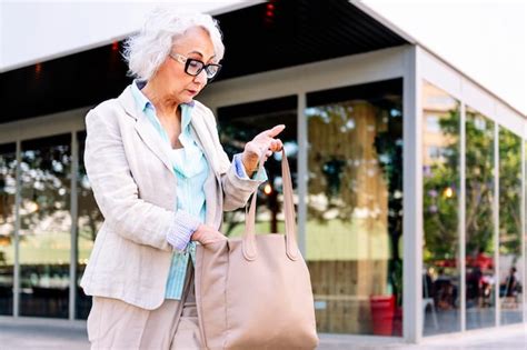 Premium Photo Stylish Mature Woman Looking In Her Bag