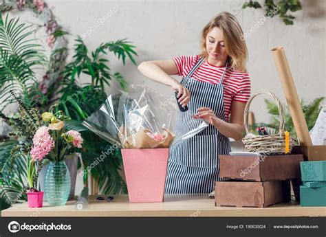 Image Of Young Florist With Stapler Decorating Floral Composition At