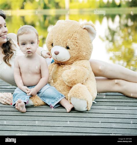 Mother Looking After Her Playing Son Stock Photo Alamy