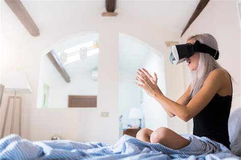 Premium Photo Amazed Young Woman Sitting In Bed Wearing Vr Glasses
