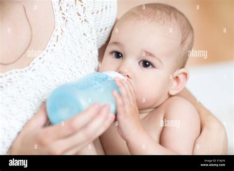 Mother Feeds Baby Milk From Bottle Stock Photo Alamy