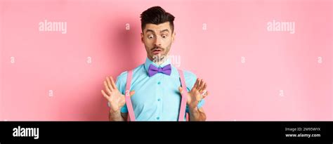 Funny Guy With Moustache And Bow Tie Adjusting His Suspenders And Looking Down With Confused
