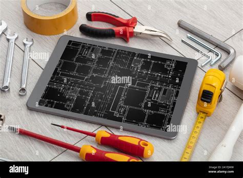 Tablet With Construction Tools And Blueprint Concept Stock Photo Alamy
