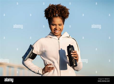 Black Woman With Afro And Dental Braces Wearing White Jacket And