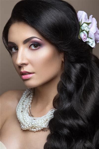 پرتره یک زن سبزه زیبا در تصویر عروس با گل در موهایش عکس گرفته شده در