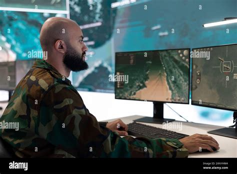 Infantry Unit Officer Examines Big Data On Pc In Military Control Room Employing High Tech Anti
