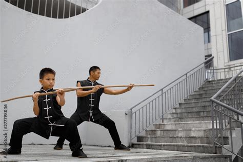 Son And Father Are Engaged In Wushu Morning Wushu Training In The City