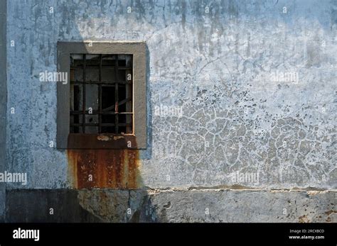 Rust Coloring A Wall Underneath A Gated Window Stock Photo Alamy
