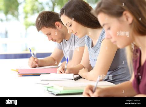 Three Babes Taking Notes During A Class In A Classroom Stock Photo Alamy