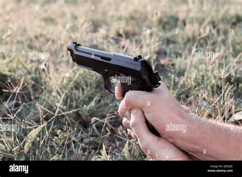pistol in male hands fingers pull the trigger handling weapons