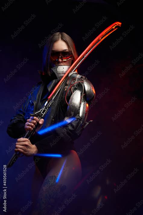 Atmospheric Portrait Of A Beautiful Female Assassin Posing In Dark