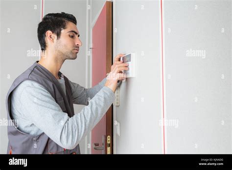 Man Fitting Keypad Next To Entrance Stock Photo Alamy