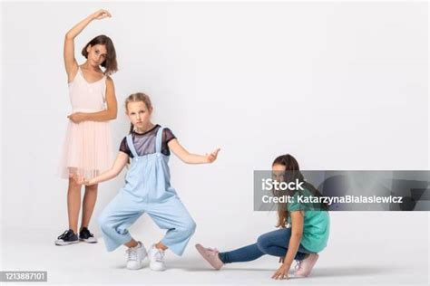 Group Of Cool Girls Fooling Around In White Room Making Funny Poses