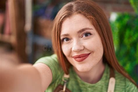 Young Redhead Woman Florist Smiling Confident Make Selfie By Camera At