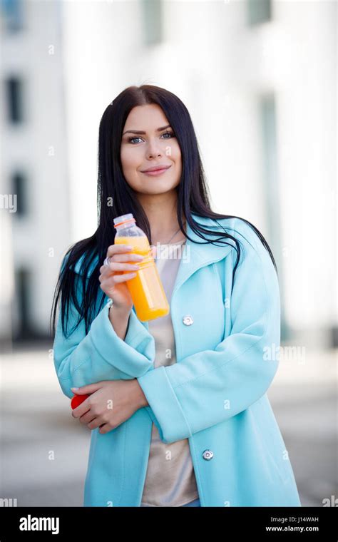 Girl holding bottle orange juice hi-res stock photography and images - Alamy