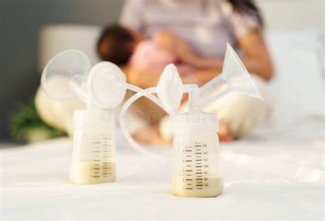 The Breast Milk Are In The Bottles Of Electric Breast Pumping Set On