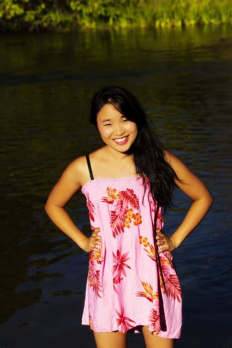 Smiling Japanese American Woman Standing In Floral Dress Stock Image