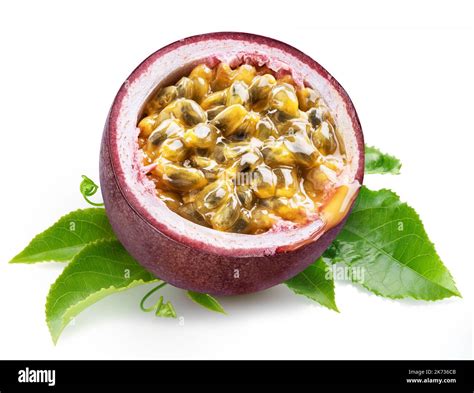 Dark Purple Passion Fruit Half With Seedy Interior Laying On Green