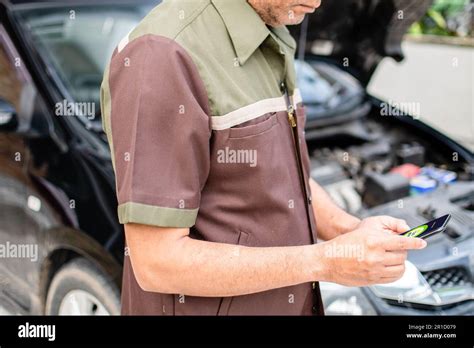 Technician Holds Smartphone To Watch The Battery Function Monitor Mobile Device Screen Show