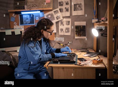 Female Technician Repairing Broken Laptop Notebook Computer With A Screwdriver Working In Retro