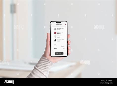 Smartphone Screen Showing A Shopping Cart Filled With Clothing Items