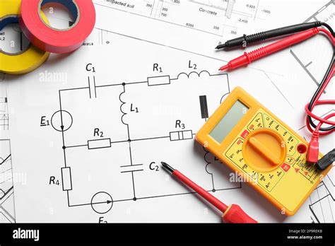 Digital Multimeter And Tapes On Paper Sheets Flat Lay Electricians