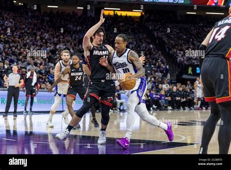 Sacramento Kings forward DeMar DeRozan, right, drives to the basket with Miami Heat guard Jaime ...