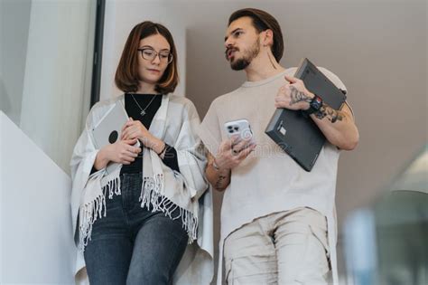 Successful Young Coworkers Analyzing Statistics And Discussing Project Solutions In Modern