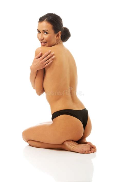 Nude Woman Sitting On Knees Embracing Herself Stock Image Image Of