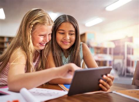 Enhancing The Learning Experience Two Young Girls Using A Digital