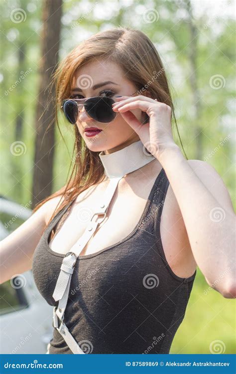 Beautiful Young Girl With A Large Chest Next To The Big White Suv