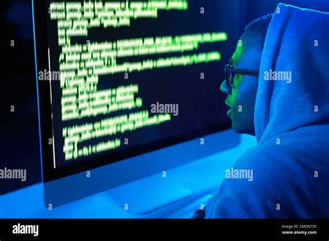 Hes One Hack Away From His End Goal A Young Male Hacker Cracking A Computer Code In The Dark