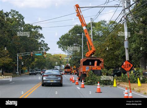 A Worker Pruning A Tree At Height In A Storm Damage In The Broken Trees After Tornado Stock