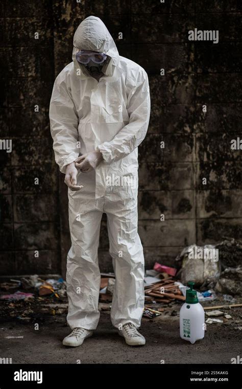 Man In Personal Protective Equipment Ppe Suit Wearing Clear Glasses And Gas Mask Preparing To