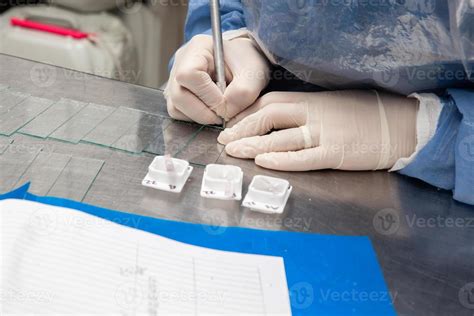 Scientist Preparing Paraffin Blocks Containing Biopsy Tissue For Sectioning Pathology