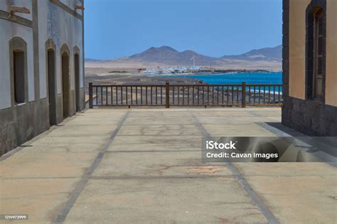 푸에르토 데 라 크루즈 푼타 얀디아 푸에르테벤투라 카나리아 제도 스페인의 파도가 있는 풍차와 해변이 있는 어촌 마을의 전경 건조한에 대한 스톡 사진 및 기타 이미지 Istock